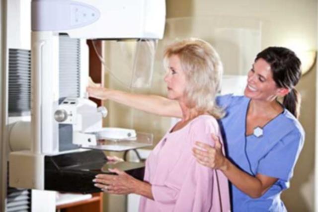 Nurse with patient getting mammogram